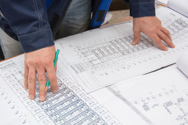 Man Holding Blueprints at Construction Site Stock Photo - Image of clip ...