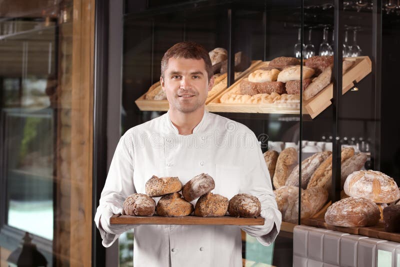 Man Holding Board with Assortment of Fresh Bread in Bakery Stock Image ...