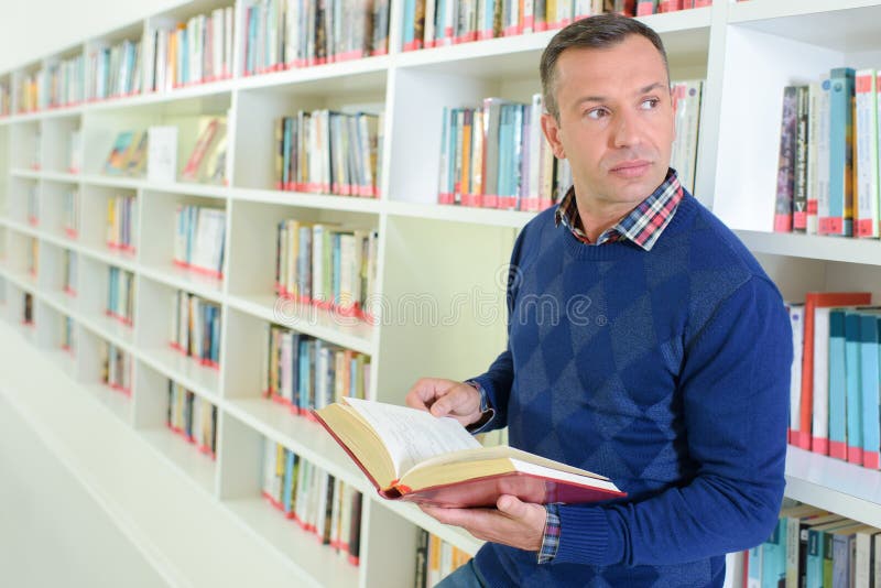 Man holding a book stock image. Image of publication - 123595311