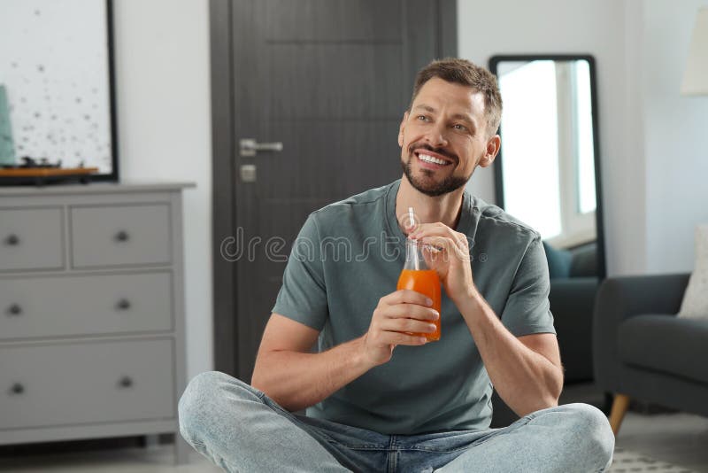 Man Holding Bottle of Delicious Juice at Home Stock Photo - Image of ...