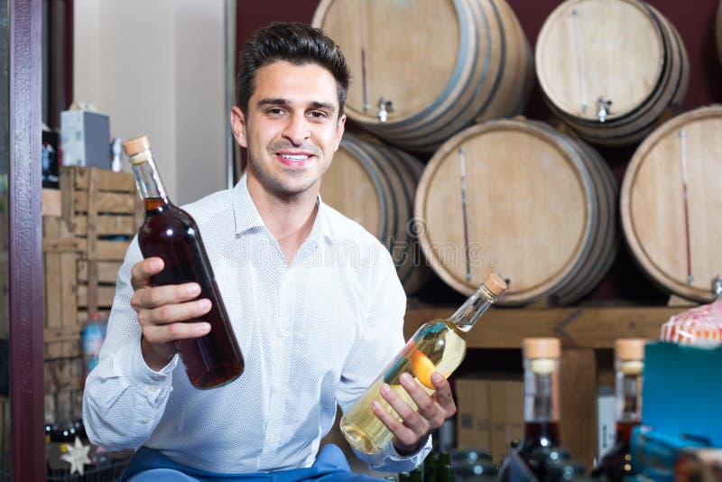 Man Holding Bottle of Wine in Cellar Stock Image - Image of american ...