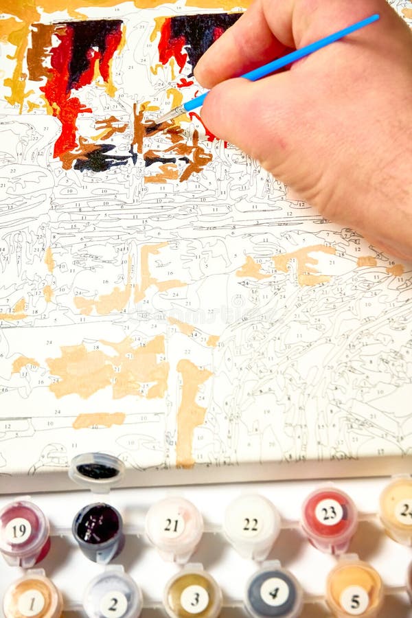 Man Holding a Brush and Paints a Picture, Drawing by Numbers. Stock ...