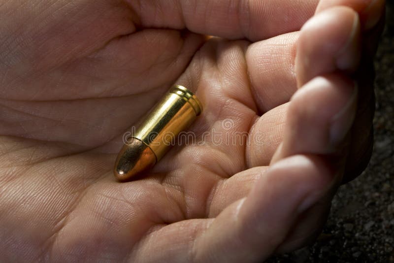 Man Holding Bullets in Hand Stock Photo - Image of evidence, lighting ...