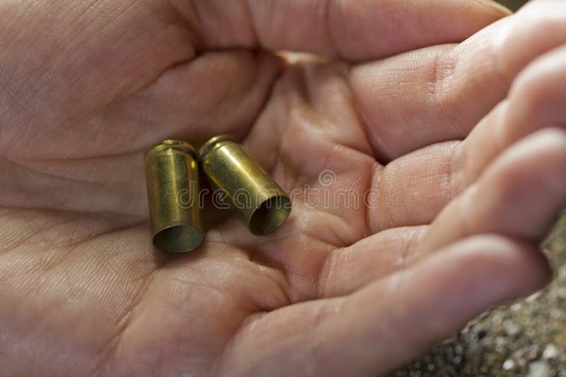 Man Holding Bullets in Hand Stock Photo - Image of assault, automatic ...