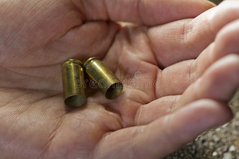Man Holding Bullets in Hand Stock Photo - Image of assault, automatic ...