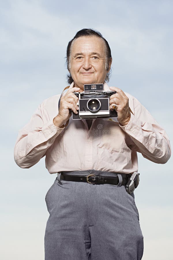 Man holding a camera stock image. Image of photographer - 62563391