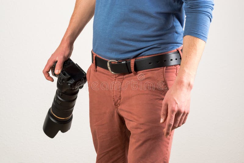 Man is Holding a Camera Near His Hip Stock Photo - Image of digital ...