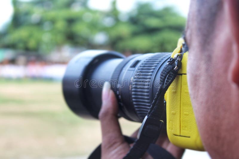 Man Holding a Camera Shooting Objects at the Field during the Day Stock ...