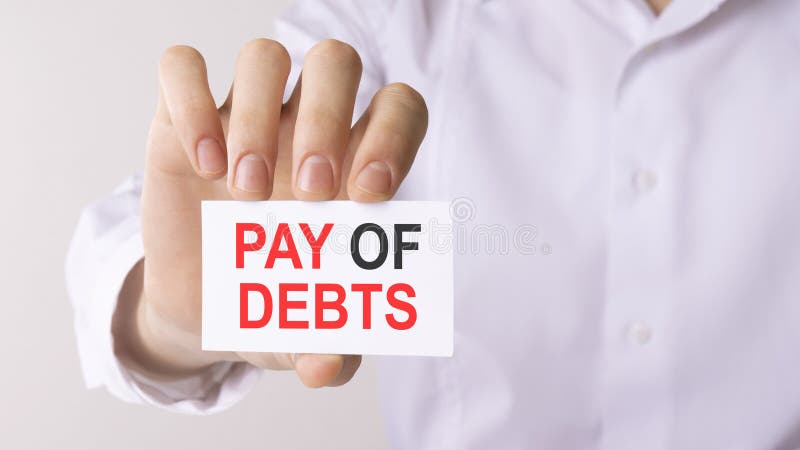 Man Holding a Card with Text Pay Off Debts Stock Image - Image of ...