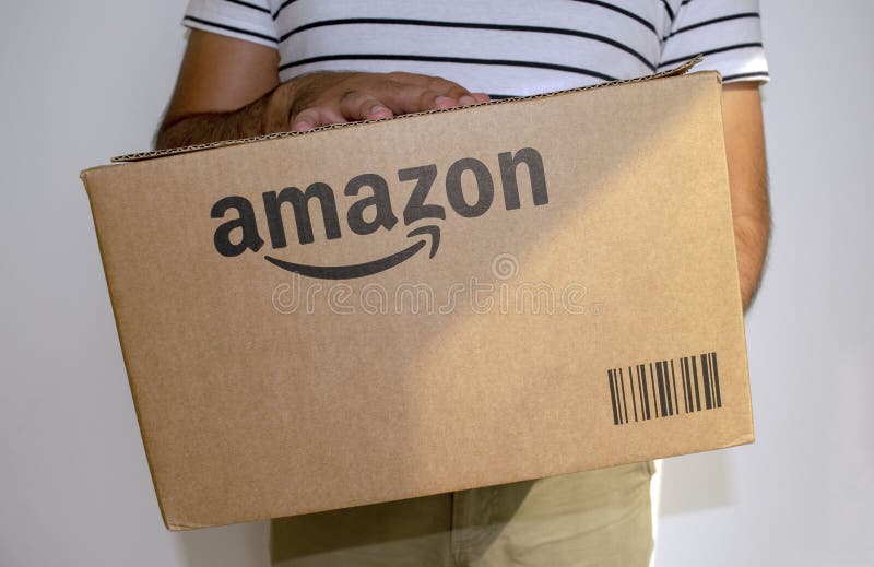 Man is Holding Cardboard Box Parcel of Amazon. Amazon Delivery Package ...