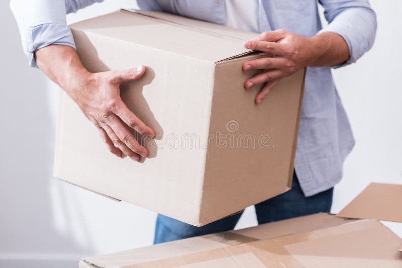 Man holding cardboard box stock image. Image of indoors - 99815703