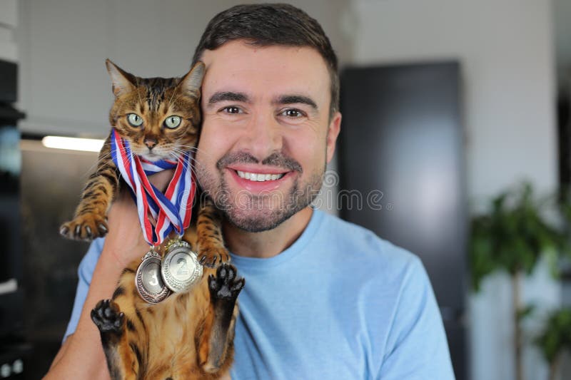Man Holding a Cat that Has Won Several Medals Stock Image - Image of ...