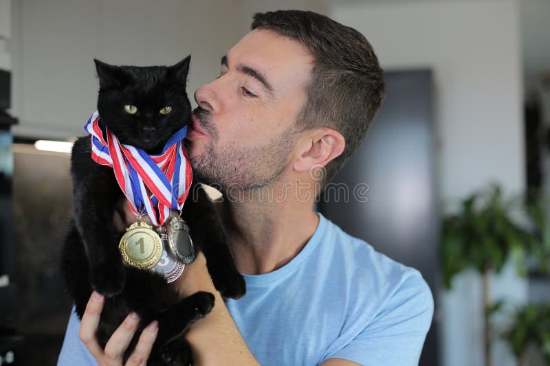 Man Holding a Cat that Has Won Several Medals Stock Photo - Image of ...
