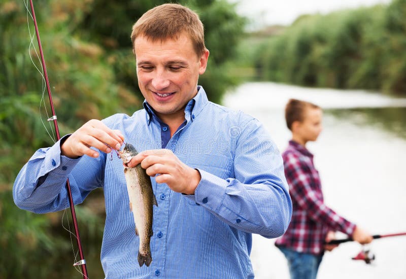 Man holding catch fish stock image. Image of lake, adult - 85083437