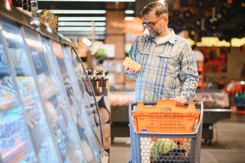 Man Holding Cheese in Front of Grocery Store Stock Image - Image of ...