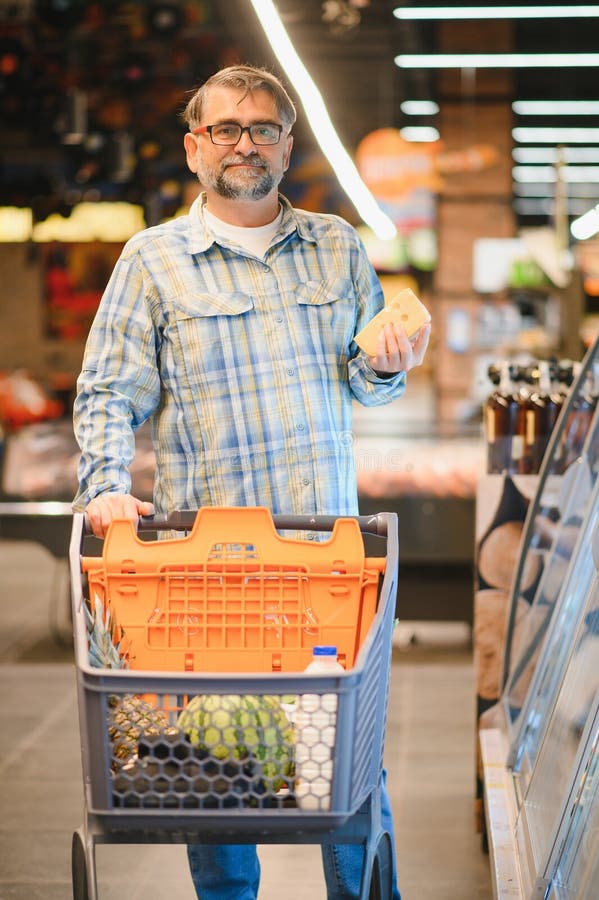 Man Holding Cheese in Front of Grocery Store Stock Image - Image of ...