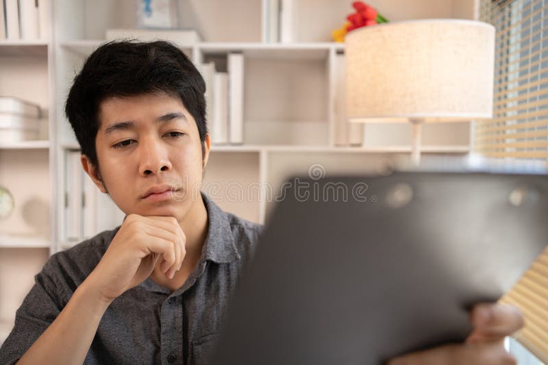 Man Holding a Clipboard Analyzing Finances in Office Stock Photo ... Man Holding a Clipboard Analyzing Finances in Office Stock Photo ...