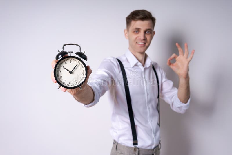 A Man is Holding a Clock and Giving the Thumbs Up Sign Stock Photo ...