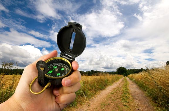 Man Holding Compass in Field Stock Image - Image of instrument, feed ...