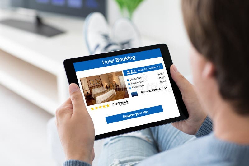 Man Holding Computer with App Hotel Booking Screen in Cafe Stock Photo ...