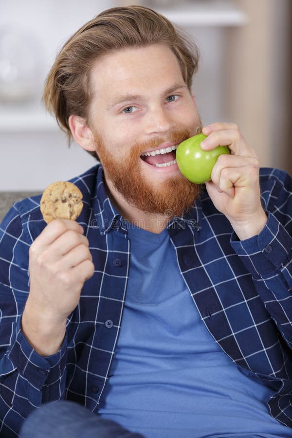 Man biting into an apple stock photo. Image of fruit - 22184566