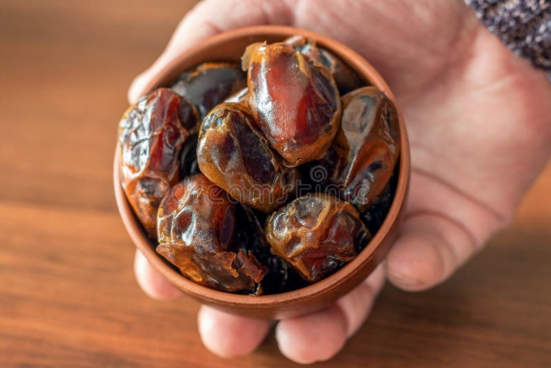 Man Holding a Cup with Dates, Top View Stock Image - Image of cuisine ...