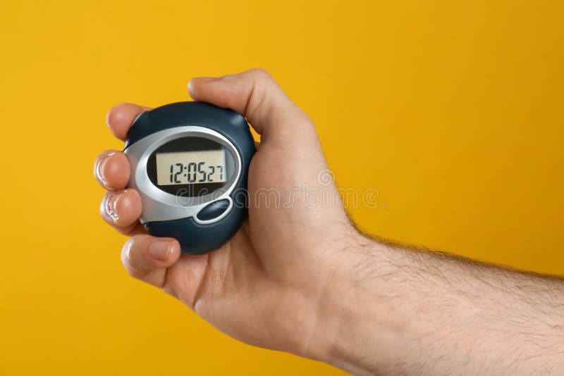 Man Holding Digital Timer on Yellow Background, Closeup Stock Image ...