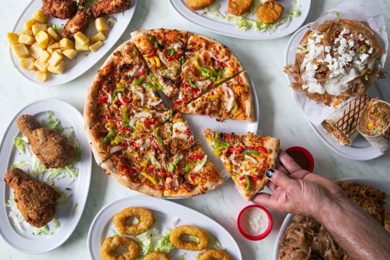 Man Holding a Doner Pizza Slice on a Restaurant Table Stock Image ...