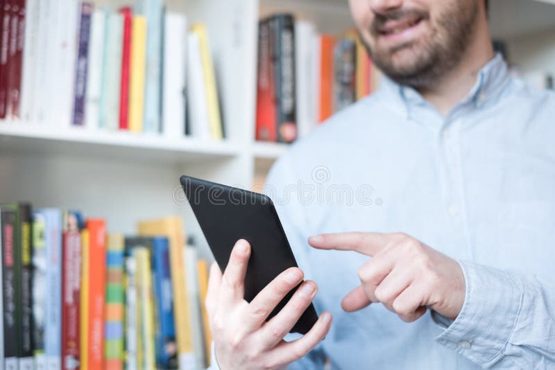 Hands Holding And Keeping Ebook On Bookshelf Background Stock Photo ...