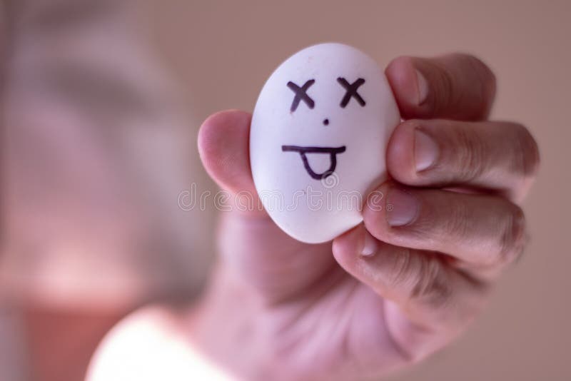 A Man Holding an Egg with a Funny Face. Conceptual Image Stock Image ...
