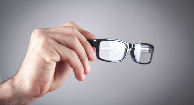 Man Holding Eyeglasses in Office Stock Image - Image of vision, glasses ...