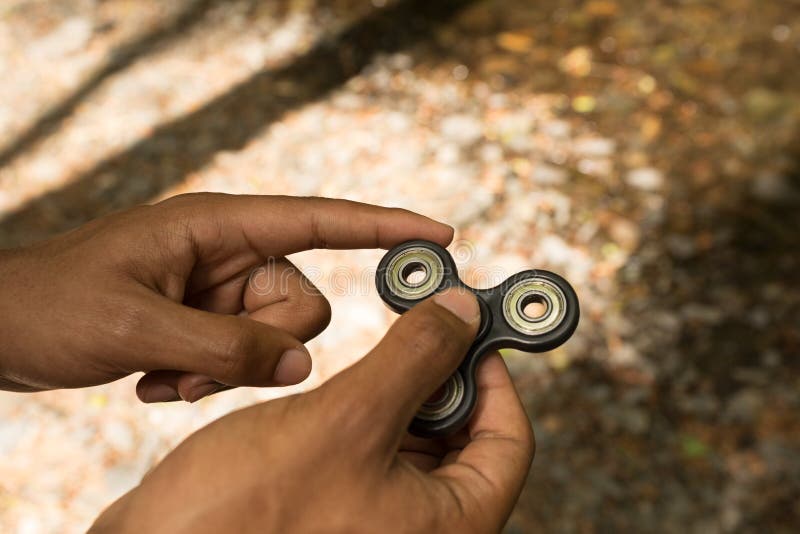 Man Holding a Fidget Spinner Stock Image - Image of playground ...