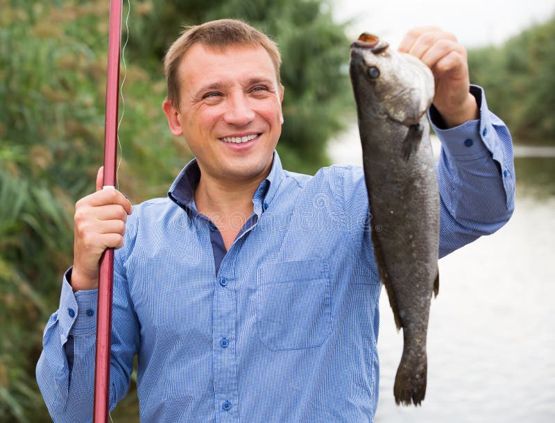 Man Holding Fish after Fishing Stock Photo - Image of pole, bait: 89938784