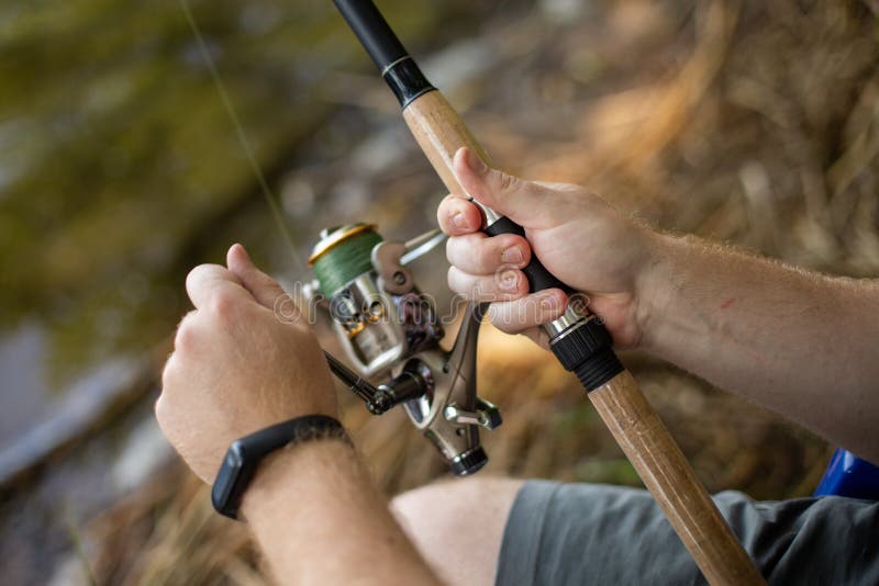Man Holding the Fishing Rod and Fishing Stock Image - Image of gear ...