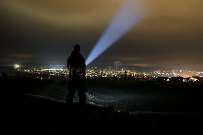 Man Holding a Flashlight and Illuminating the Sky Stock Photo - Image ...