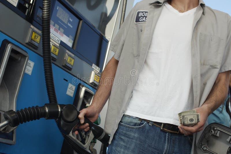Gas Pump with Money in the Nozzle Stock Image - Image of fuel, road ...