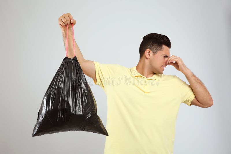Man Holding Full Garbage Bag on Blue Background Stock Image - Image of ...