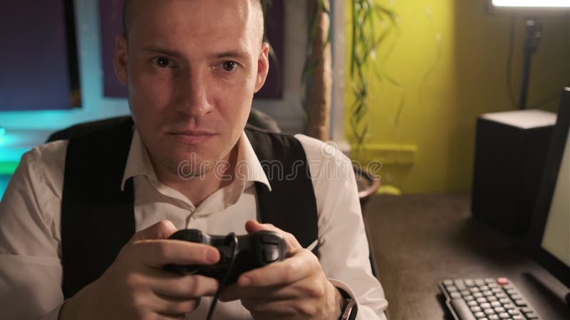 Man Holding Game Controller in Front of Computer. he Appears Focused ...