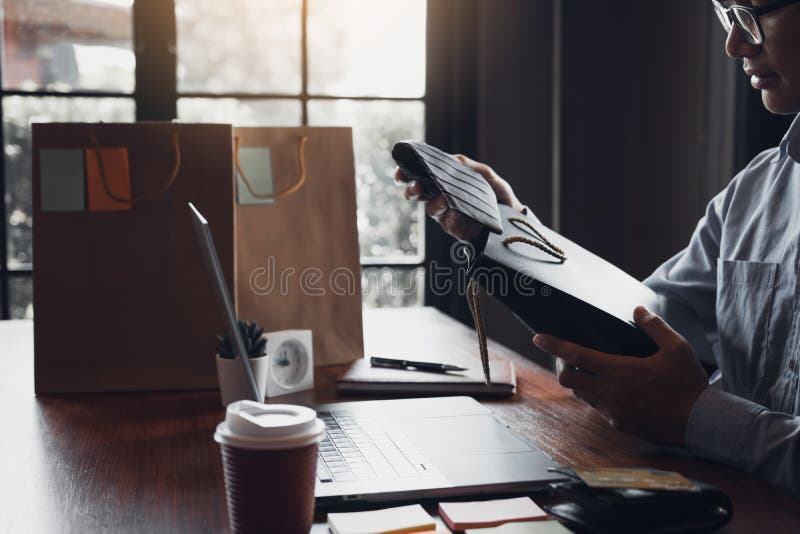 Man Holding a Gift Bag with a Necktie Inside Out As a Gift at the Cafe ...