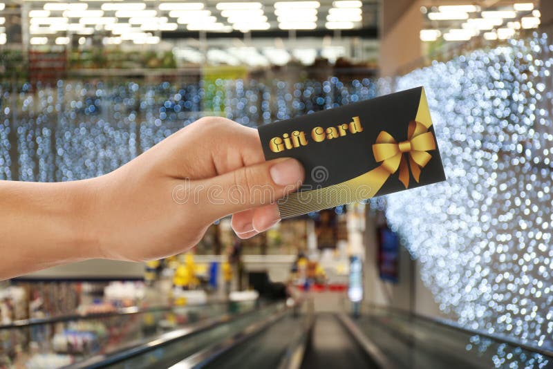 Man Holding Gift Card in Shopping Mall, Closeup Stock Photo - Image of ...