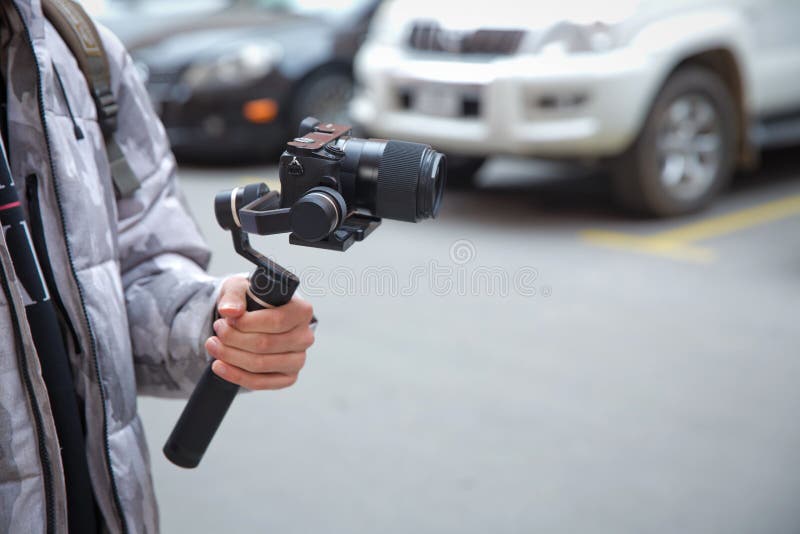 Man Holding Gimbal Stabilizer Outdoor. Gimbal Operator with Black ...