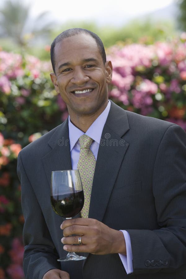 Man Holding a Glass of Wine Stock Image - Image of standing, male: 29651007