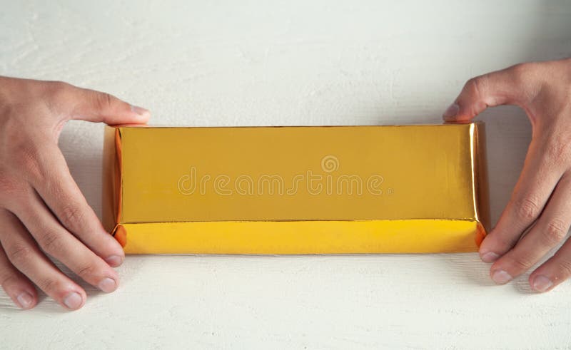 Man Holding Gold Bar on White Desk Stock Image - Image of success ...