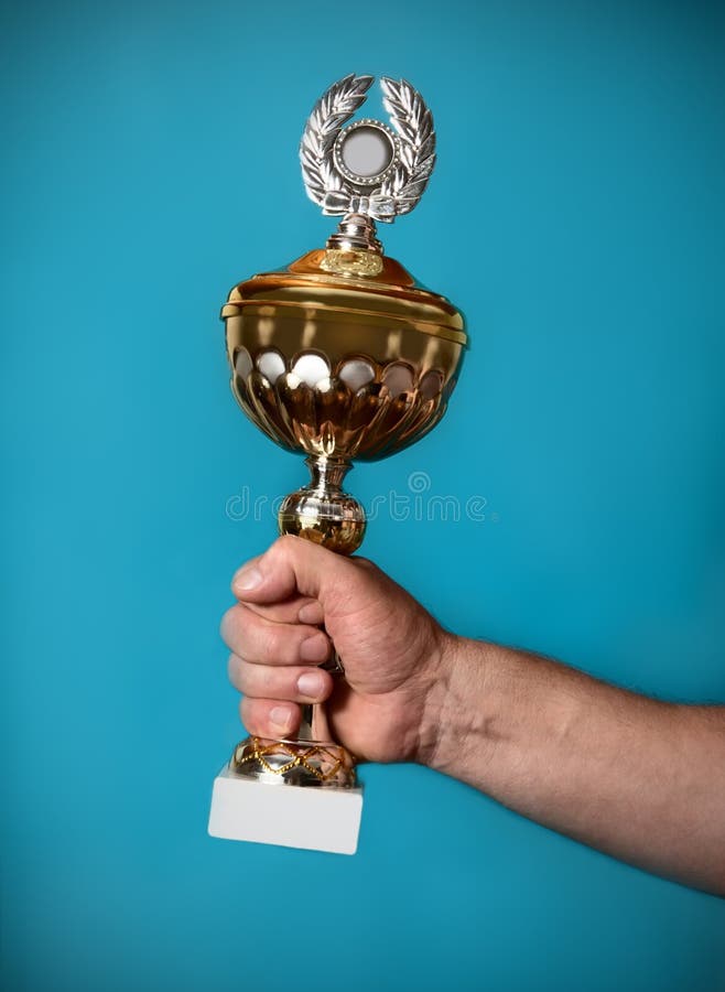Man Holding a Golden Trophy Stock Photo - Image of cloud, reflection ...