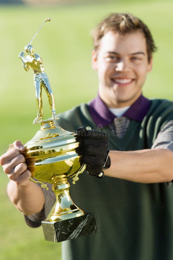 Man Holding Golf Trophy stock image. Image of hobby, adult - 29646359