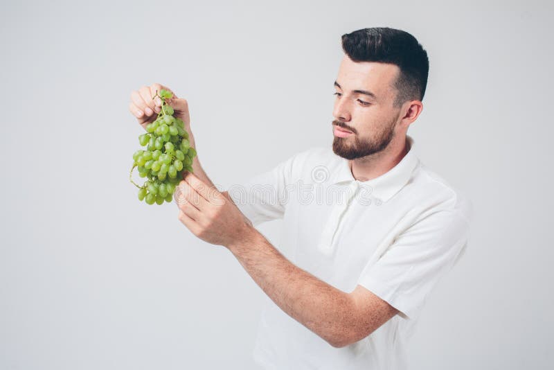 Man Holding Grape, Close Up. Concept. Isolated on White Stock Photo ...