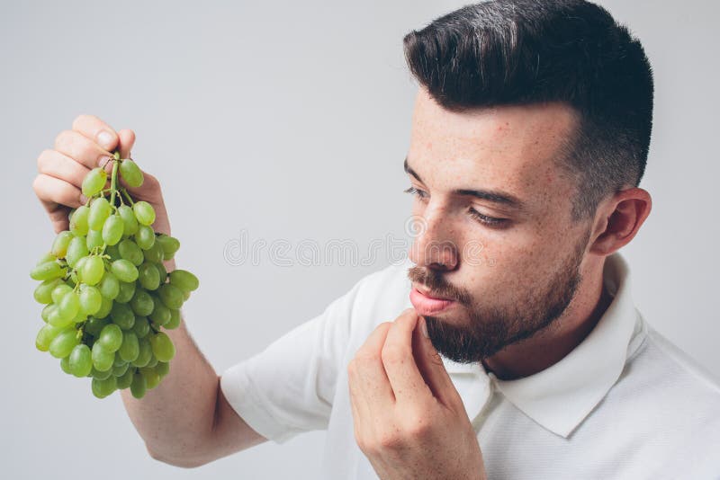 Man Holding Grape, Close Up. Concept. Isolated on White Stock Photo ...