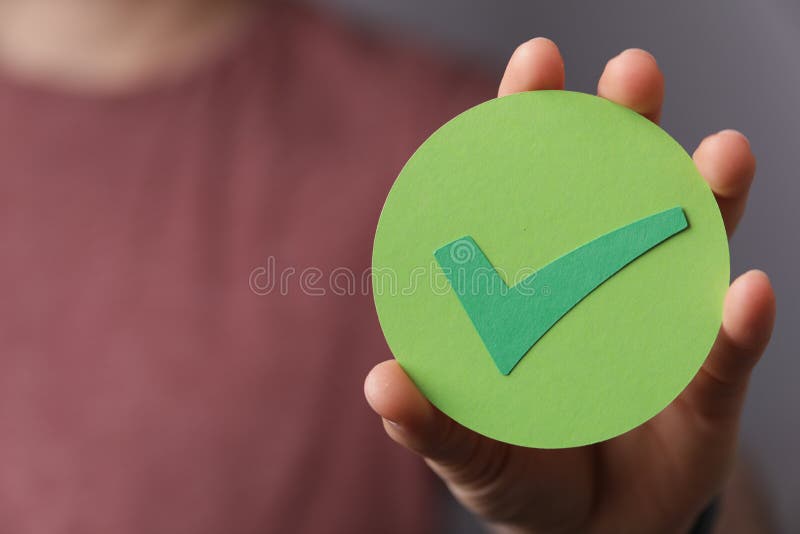 Man Holding a Green Check Mark Stock Image - Image of symbol, green ...