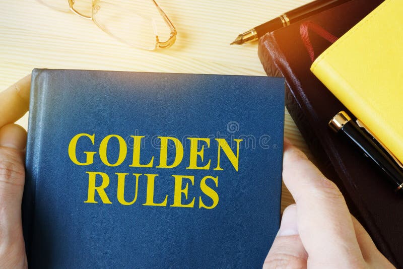 Man Holding Guide with Title Golden Rules. Stock Image - Image of ...