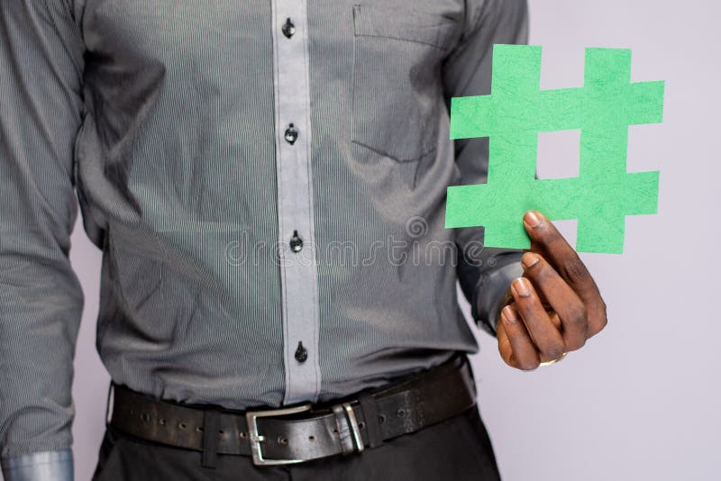 Man Holding a Hashtag Symbol Stock Photo - Image of hash, cutout: 265134872